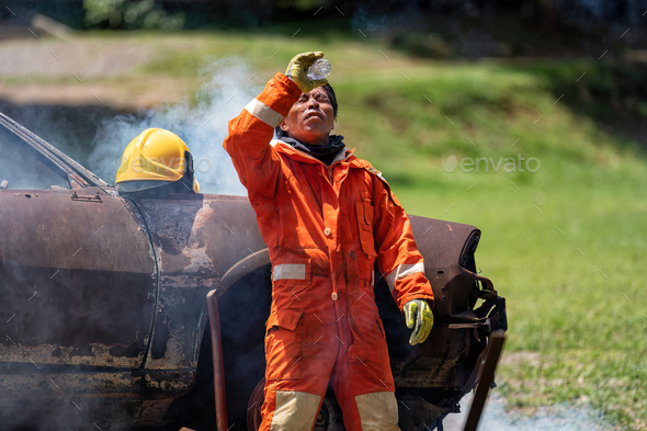 Fireman wearing fire protection suite and oxygen tank rest relax drink ...