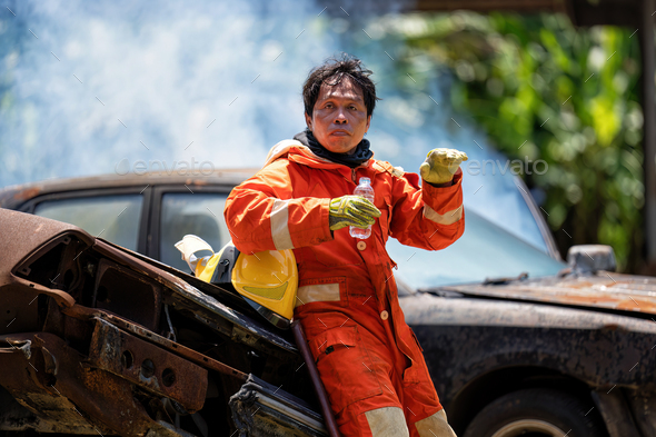 Fireman wearing fire protection suite and oxygen tank rest relax drink ...