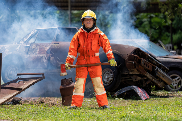 Fireman wearing fire protection suite and oxygen tank hold axe portrait ...