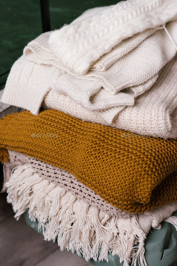 Stack of women's dresses with knitted wool sweaters or plaids. Various ...