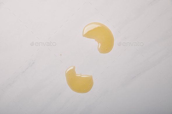 top view of spilled yellow soap on white marble Stock Photo by ...