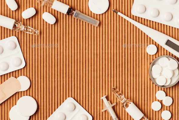 top view of various medical instruments and drugs on cardboard ...