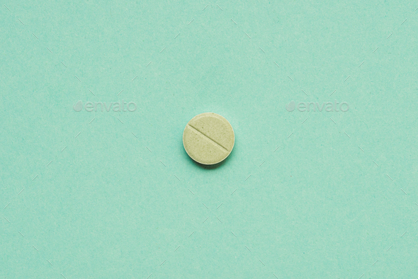 top view of round tablet on green background Stock Photo by ...
