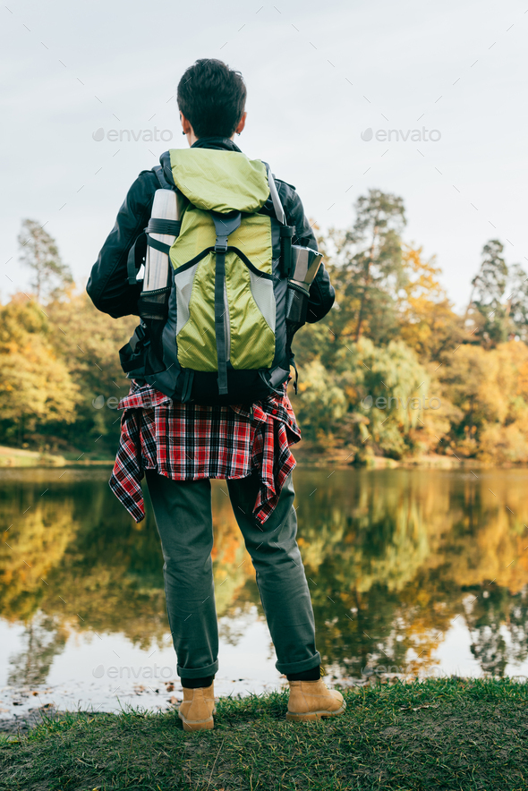 rear view of traveller with backpack on autumnal background Stock Photo ...