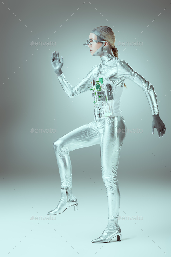 side view of futuristic cyborg walking on grey, future technology ...
