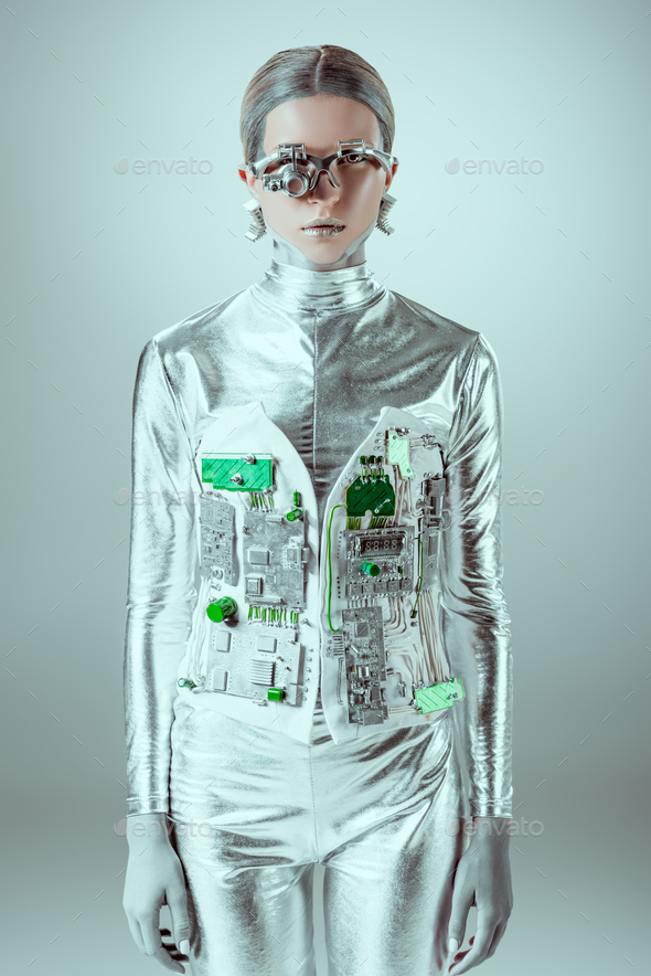 futuristic silver cyborg looking at camera isolated on grey, future ...