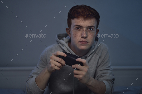 Focus caucasian teenage boy playing on game controller at night Stock ...