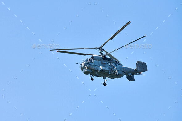 Navy helicopter flying against blue sky, copy space. One military ...