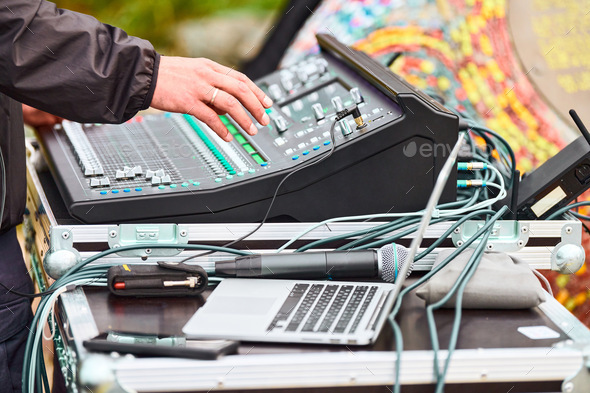Sound engineer hands working on sound mixer at live concert, stage ...