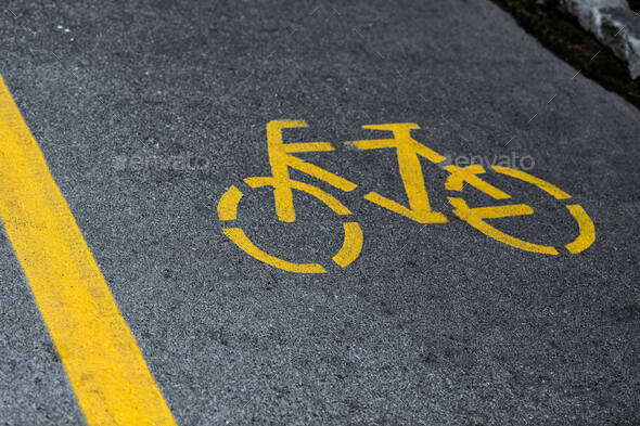 Yellow bicycle sign on sidewalk, road yellow marking for traffic safety ...