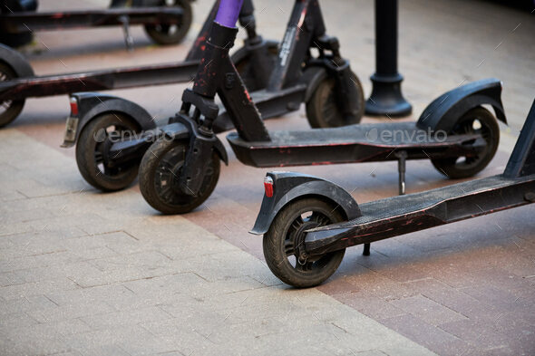 Motorized scooter parking for hourly rent on sidewalk street, vehicle ...