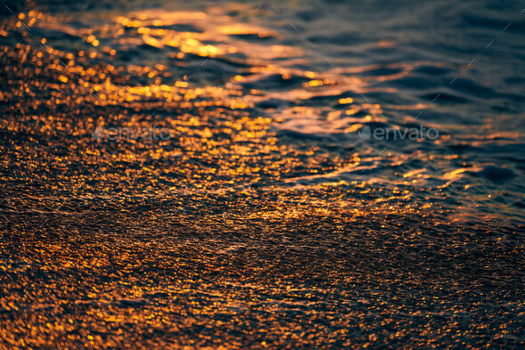 Sunset light reflection on sea sand surface, beautiful yellow sunlight ...