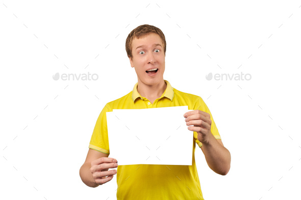 Surprised young man holding blank paper sheet, paper mockup isolated on ...