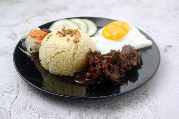 reshly cooked Filipino food called Tapsilog or thin beef slices, egg and fried rice Stock Photo ...