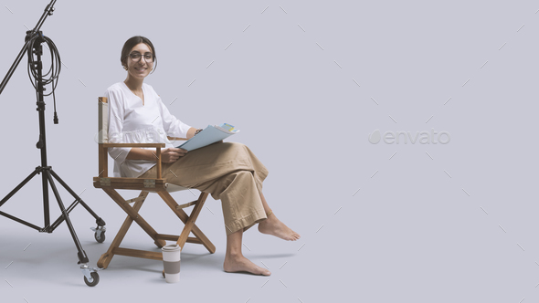 Smiling actress reading the play script Stock Photo by stokkete | PhotoDune