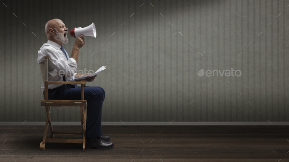 Film director shouting with a megaphone Stock Photo by stokkete | PhotoDune