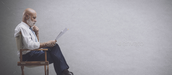 Film director reading a screenplay Stock Photo by stokkete | PhotoDune