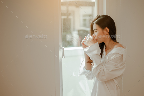 Young woman asia wake up refreshed in the morning and relaxing eat ...