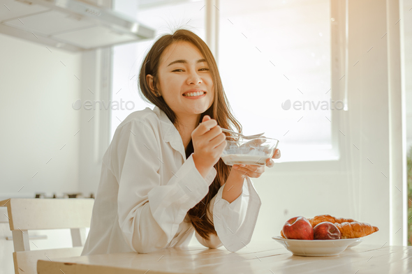 Young woman asia wake up refreshed in the morning and relaxing eat ...