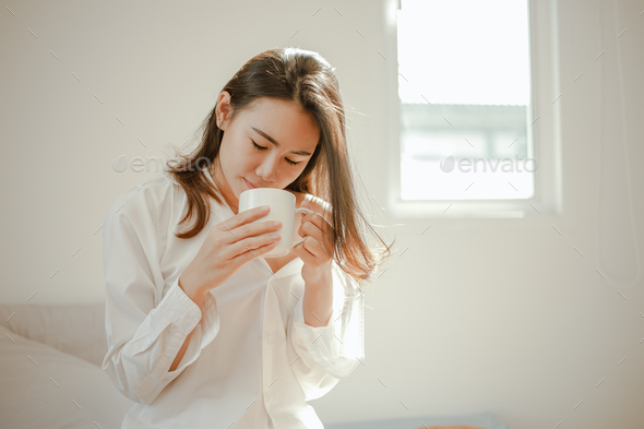 Young woman asia wake up refreshed in the morning and relaxing eat ...