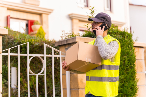 Package delivery carrier from an online store, with a box in hand ...