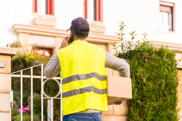 Package delivery carrier from an online store, with a box in hand ...