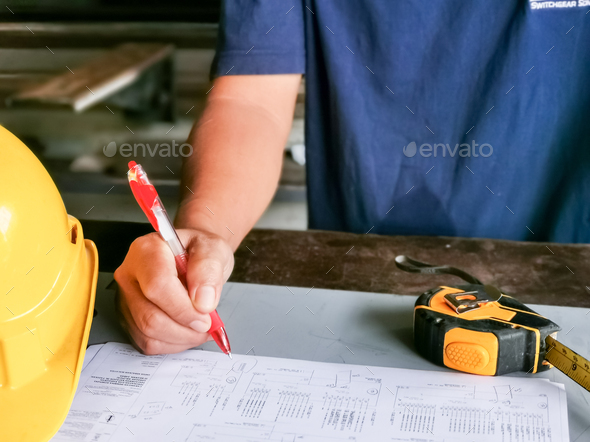 Supervisor working at factory with drawing plan. Stock Photo by ...