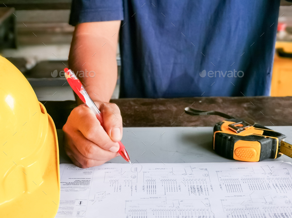 Supervisor working at factory with drawing plan. Stock Photo by ...