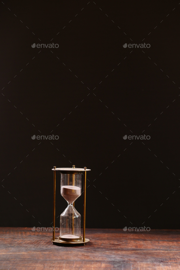 hourglass on table, sand flowing through the bulb of sandglass Stock ...