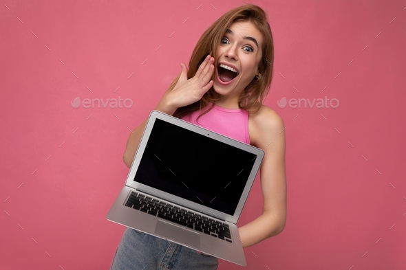 Beautiful amazed surprised young woman holding computer laptop with ...