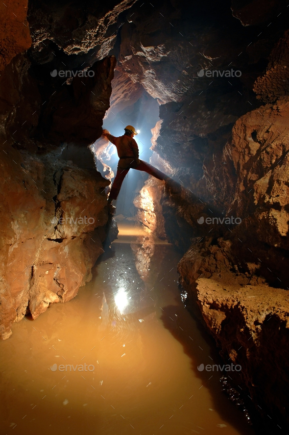 Silhouette of a cave explorer in the underground Stock Photo by salajean