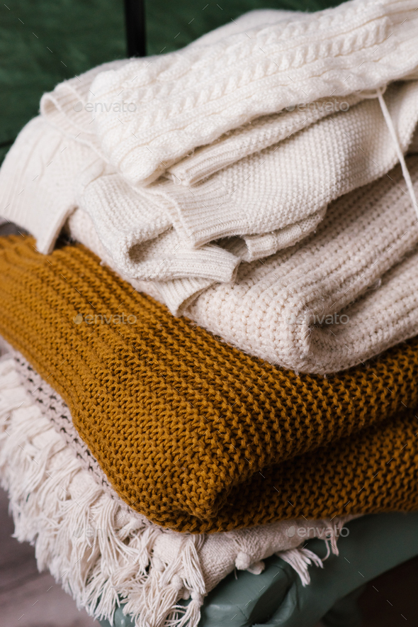 Stack of wool knitted sweaters. Stock Photo by LeylaCamomile | PhotoDune