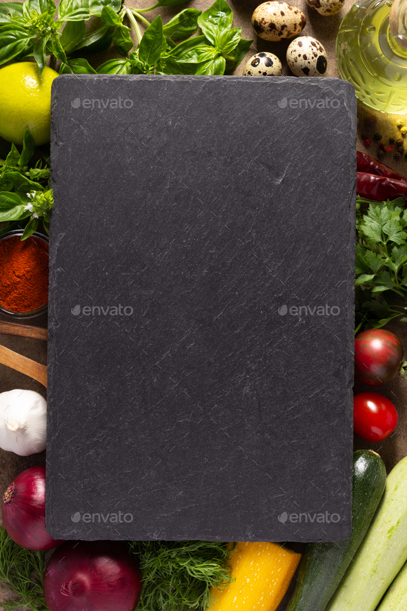 Variety of fresh vegetables slate stone at table background. Cooking ...
