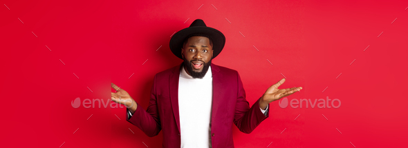 Image of confused Black man asking question, spread hands sideways and ...