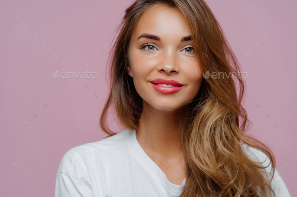 Horizontal cropped image of pleasant looking female model has tender ...
