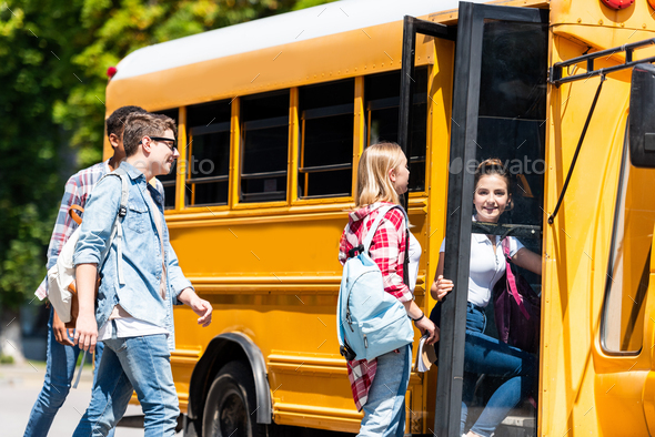group of happy teen scholars entering school bus after lessons Stock ...