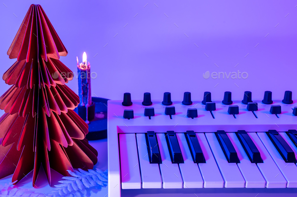 Christmas background with midi keyboard and holiday decor with neon ...