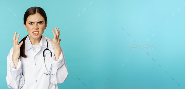 Angry and outraged woman shaking hands, cursing and looking furious ...