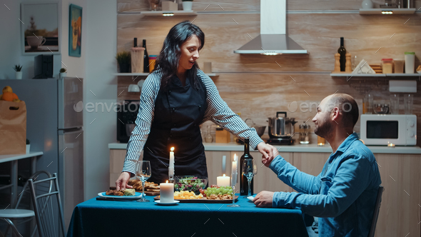 Delighted wife serving husband Stock Photo by DC_Studio | PhotoDune