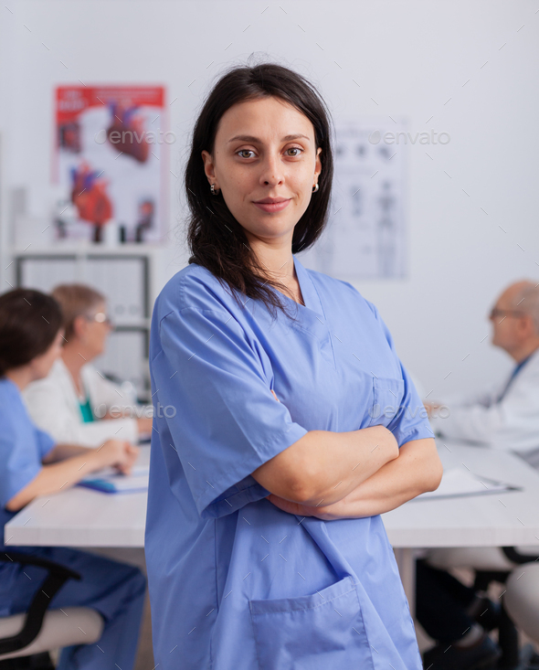 Portrait of cardiologist woman with stethoscope looking into camera ...