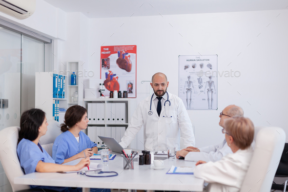 Medical team having meeting in hospital conference room planning ...
