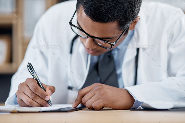 Completing notes on a new assessment Stock Photo by YuriArcursPeopleimages
