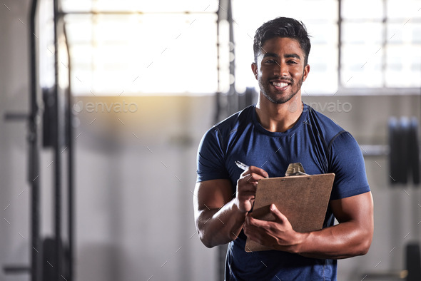 Gym, workout and personal trainer with clipboard consulting a training ...