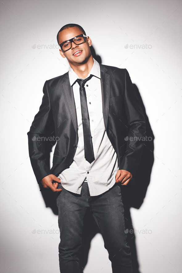 Man fashion model posing against a studio background Stock Photo by ...