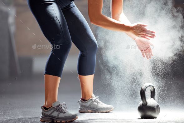 Fit, active, kettle bell of female in fitness clapping hands of chalk ...