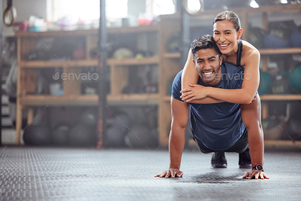 Fitness couple having fun while man does push ups and exercise together ...
