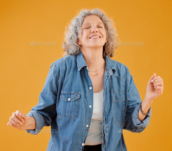 Smiling mature woman celebrating, dancing and being carefree, happy and ...
