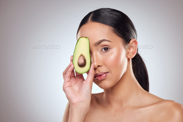 Studio portrait of a beautiful young woman posing with an avocado ...