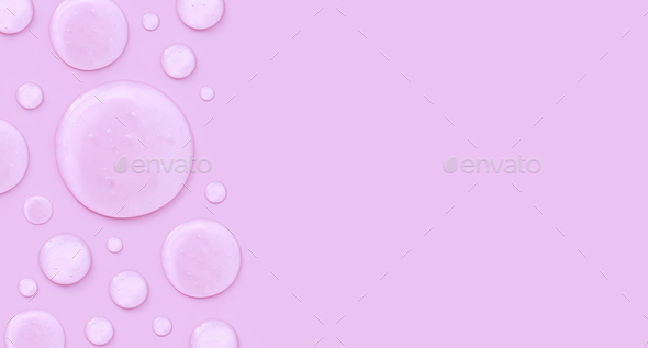 round drops of transparent gel serum on pink background Stock Photo by ...