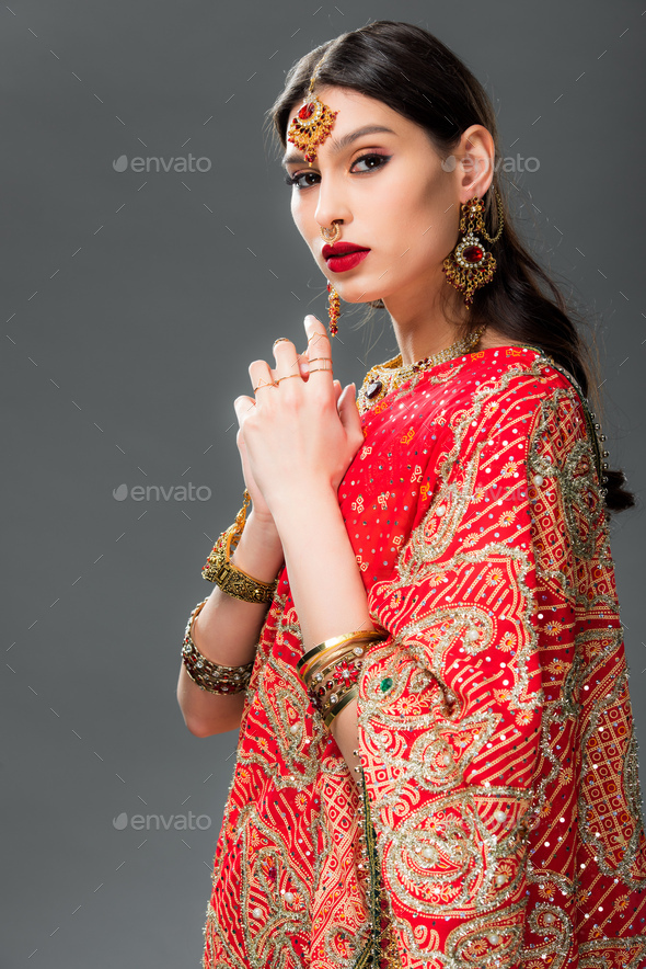 attractive indian woman in sari and bindi, isolated on grey Stock Photo ...